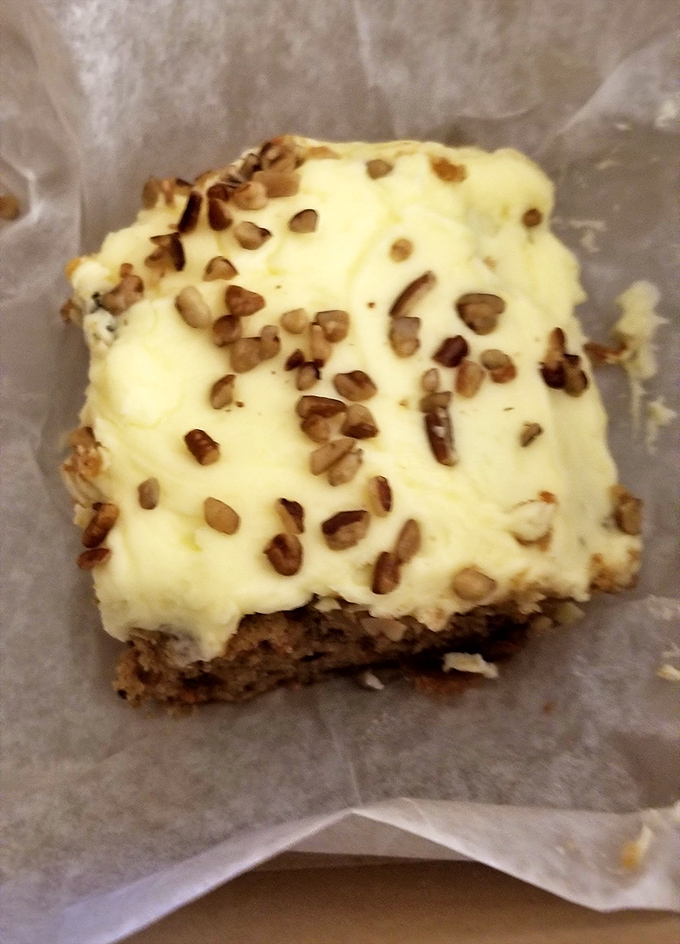 A slice of carrot cake with cream cheese frosting and pecan bits that would make even the most dedicated gym-goer reconsider their life choices.