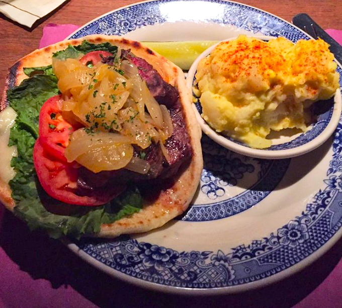 A sandwich that refuses to be ordinary. That caramelized onion topping is the crown jewel on a throne of perfectly cooked beef.