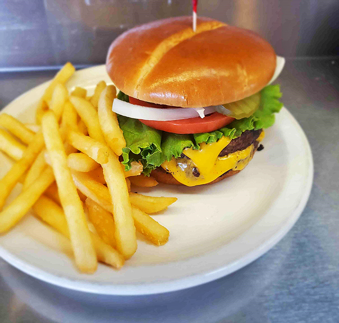A cheeseburger built the old-fashioned way with fresh lettuce, tomato, and that perfect golden bun.