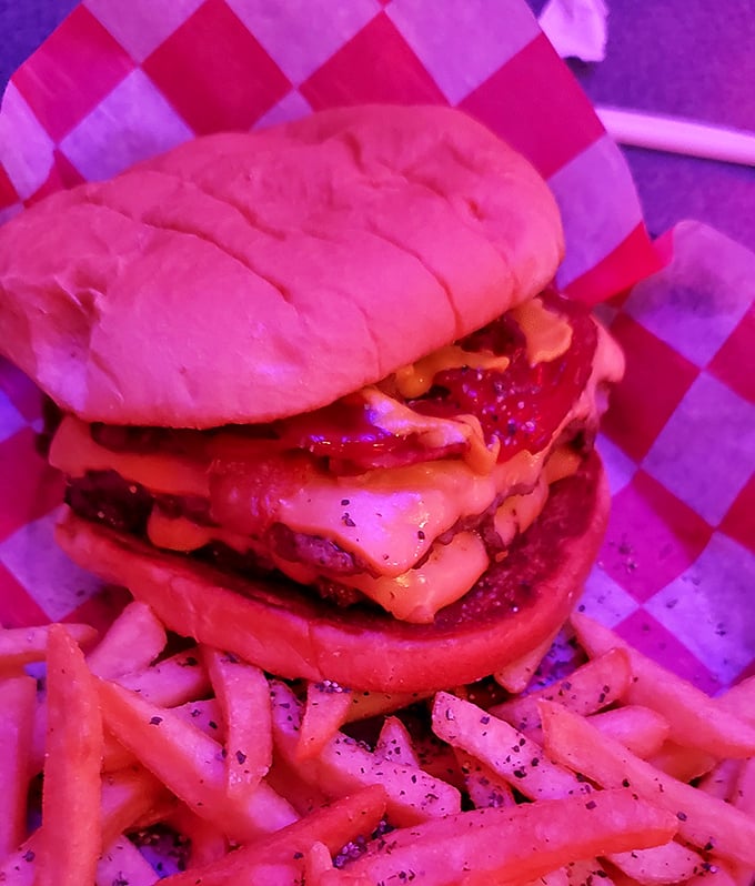 A burger that requires both hands and a strategy &ndash; stacked high with melty cheese and served with fries that look like they've never seen the inside of a freezer.