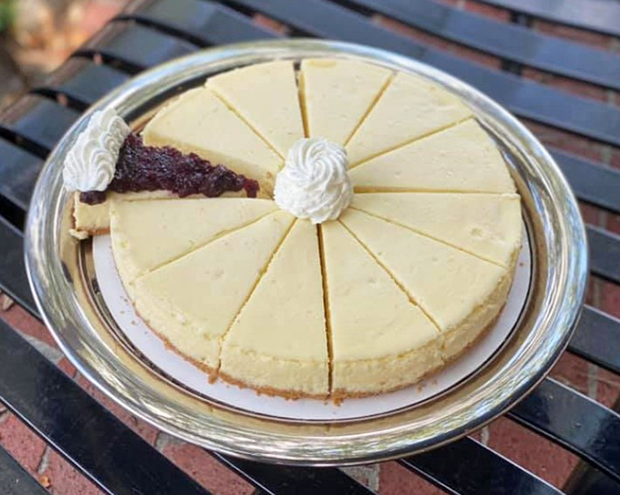 Cheesecake sliced with mathematical precision&mdash;because sharing is caring, but equal portions prevent dessert drama.