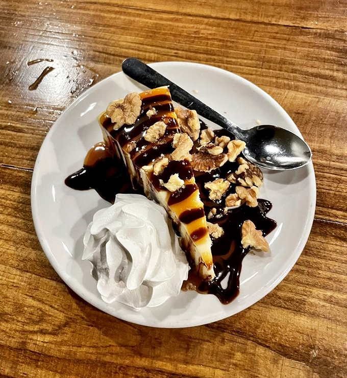A slice of cheesecake that makes you wonder why you ever waste stomach space on anything else. Those walnuts and caramel drizzle are just showing off.