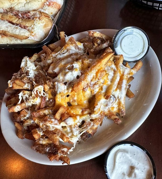 Cheesy fries that blur the line between side dish and main event. That melty cascade of cheese and pulled pork creates a fork-worthy masterpiece.