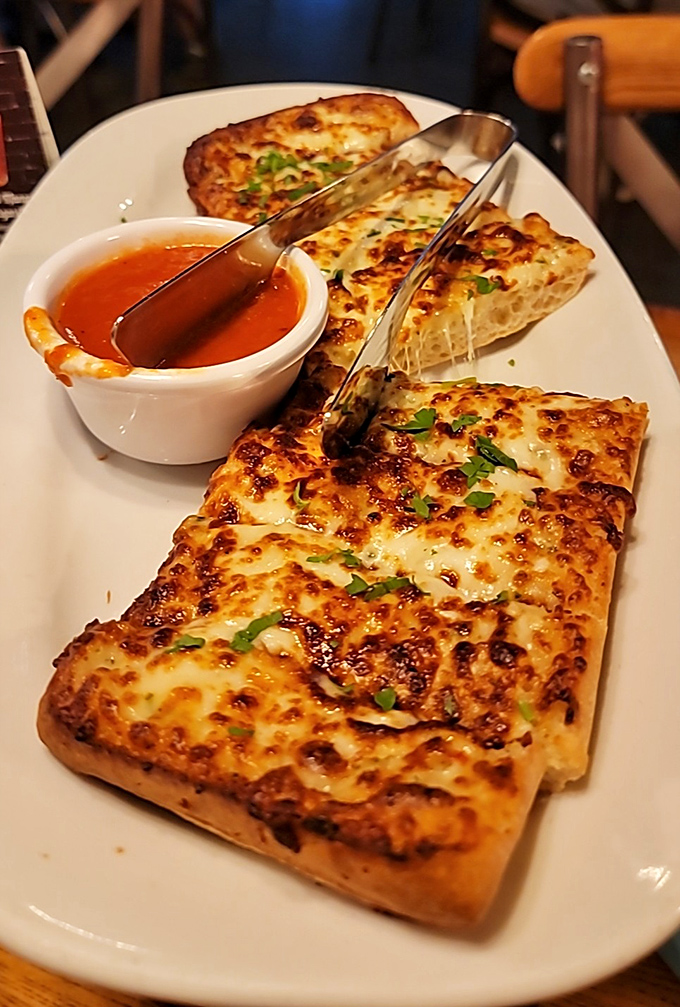 Cheesy garlic bread that makes sharing a moral dilemma. That marinara dipping sauce is the wingman this bread deserves.