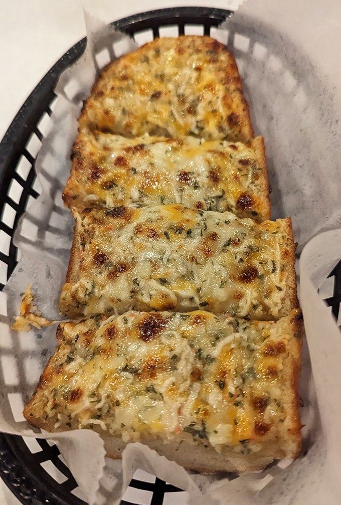 Cheesy garlic bread – because sometimes you need a break from cracking shells to enjoy carbs that fight back less aggressively.