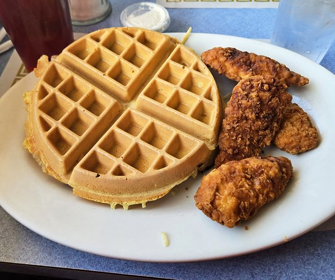 The chicken and waffle alliance proves that breakfast and dinner can peacefully coexist on one magnificent plate.