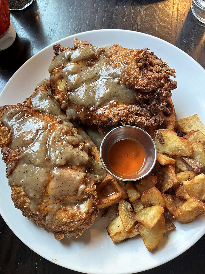 Chicken and waffles with gravy – where Southern comfort meets Midwest hospitality on a plate that would make your cardiologist wince and your taste buds sing.