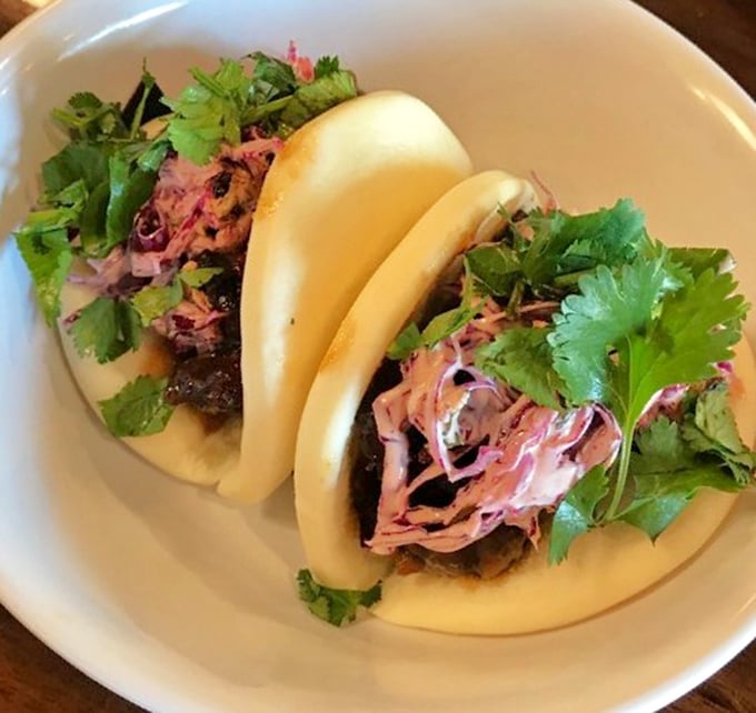 Pillowy bao buns cradle savory fillings and bright herbs &ndash; like edible clouds carrying flavor payloads straight to your happiness center.