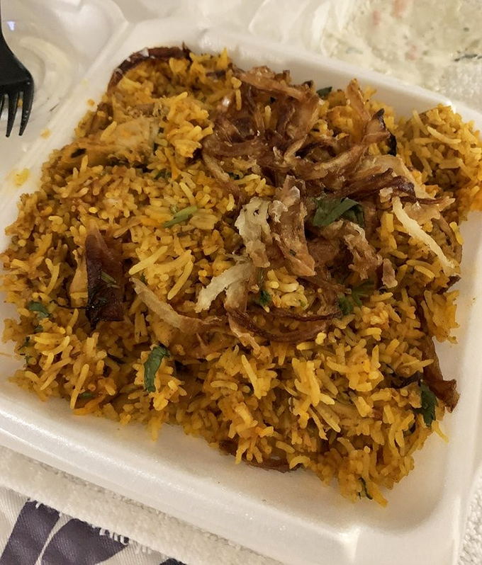 Biryani topped with crispy onions – it's like finding buried treasure, except better because it's edible.
