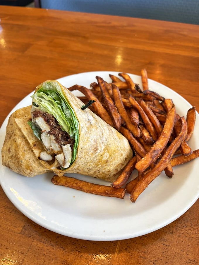 This wrap isn't just lunch&mdash;it's edible architecture, with crisp sweet potato fries standing guard like delicious sentinels.