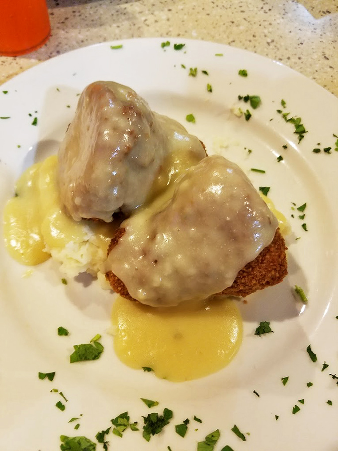 Chicken croquettes bathed in golden gravy&mdash;comfort food that whispers, "Everything's going to be okay" with every heavenly bite.