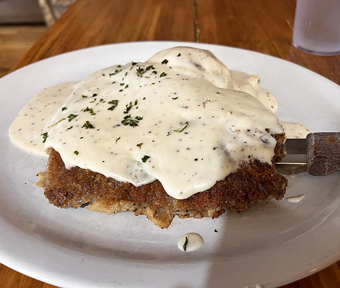 The legendary chicken fried steak, blanketed in country gravy that's practically a religious experience for comfort food devotees.