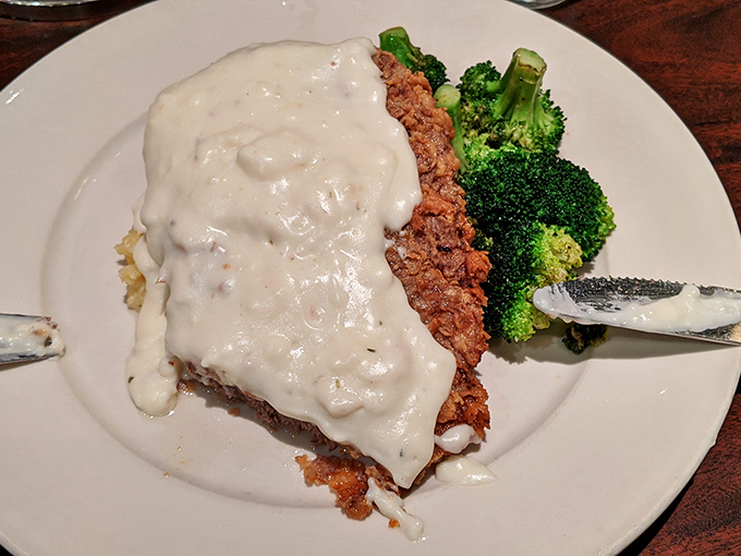 Chicken fried steak wearing its cream gravy like a comfortable sweater. Comfort food that doesn't apologize for being exactly what you need.