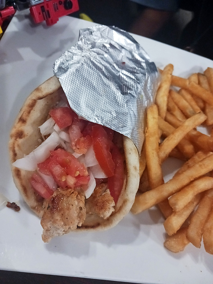 This chicken gyro wraps seasoned meat, fresh vegetables, and tangy sauce in warm pita&mdash;proof that diners do global cuisine with surprising authenticity.