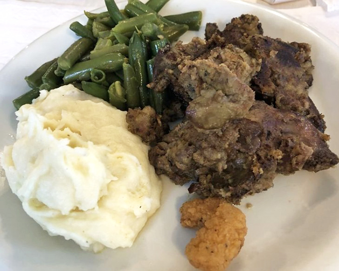 Comfort on a plate: meatloaf with mashed potatoes and green beans&mdash;the holy trinity of Midwestern cuisine that never goes out of style.