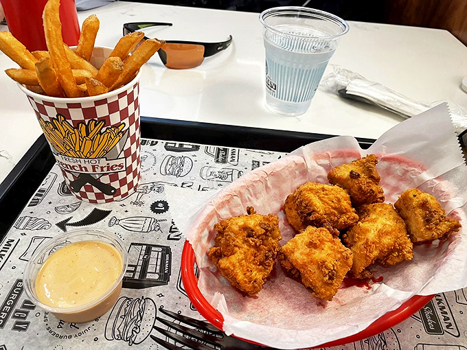 Chicken nuggets and fries presented on classic red-checkered paper&mdash;proof that childhood favorites can still deliver grown-up satisfaction when done right.