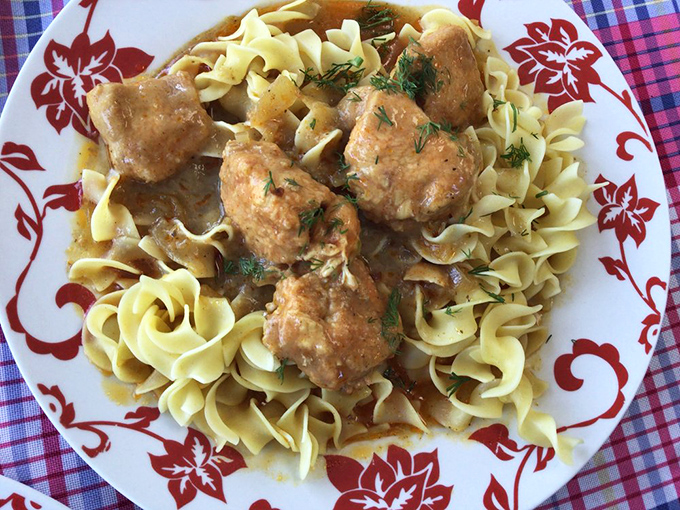Chicken paprikash over homemade noodles &ndash; where tender meat meets silky sauce. This isn't dinner; it's a warm hug from a faraway homeland.