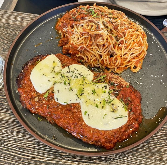 Chicken parm that's achieved the impossible trifecta: perfectly crisp exterior, juicy interior, and cheese melted to that Instagram-worthy stretch factor.
