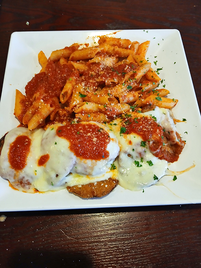 Chicken Parmesan and pasta that redefines comfort food. The melted cheese stretches dramatically with each forkful, like it's auditioning for a food commercial.