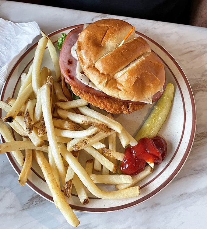 A sandwich that understands the perfect ratio of crispy chicken to soft bun, with fries that clearly graduated from potato university with honors.