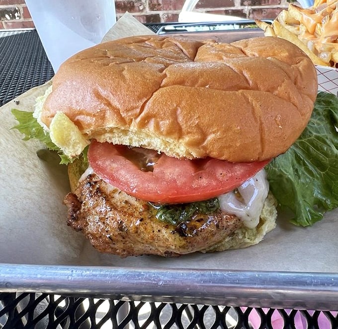Not to be outdone by its beefy brethren, the chicken sandwich stands tall with fresh toppings on a pillowy potato roll.