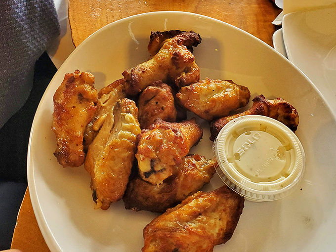 Wings that make you question why chickens don't just voluntarily fly into wood-fired ovens. The answer: they're not that selfless.