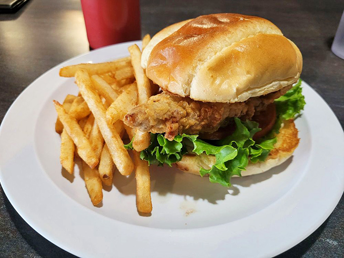 This isn't just a sandwich; it's architectural genius&mdash;crispy chicken fried steak balanced with fresh lettuce on a pillowy bun.