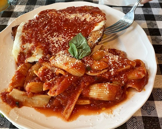 Chicken parm with pasta: the Italian equivalent of a warm hug. That basil leaf isn't garnish&mdash;it's the exclamation point on a perfect sentence.