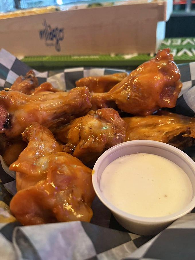 Wings glazed to perfection with sauce that glistens under the lights, served with ranch for those who like to play it safe.