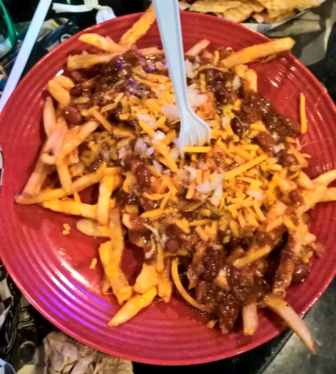 Chili cheese fries: where fork meets futility. This magnificent mess of crispy potatoes, molten cheese and hearty chili demands commitment and zero dignity.