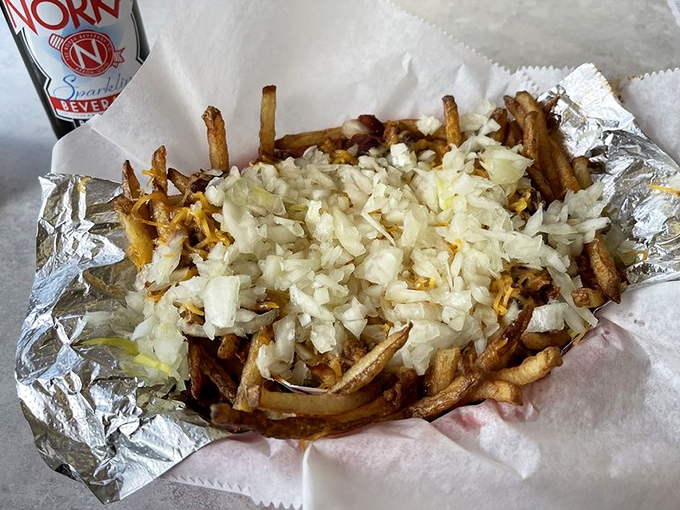 These aren't just fries—they're a foundation for a beautiful relationship between crispy potatoes, melted cheese, and diced onions.