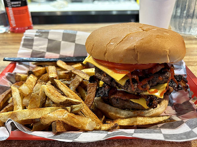The ultimate indulgence: a towering burger with melted cheese, crispy fries, and zero regrets about the nap you'll need afterward.