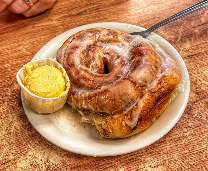 This cinnamon roll isn't just breakfast&mdash;it's an event. Glistening with glaze and paired with a generous pat of butter that's melting just right.