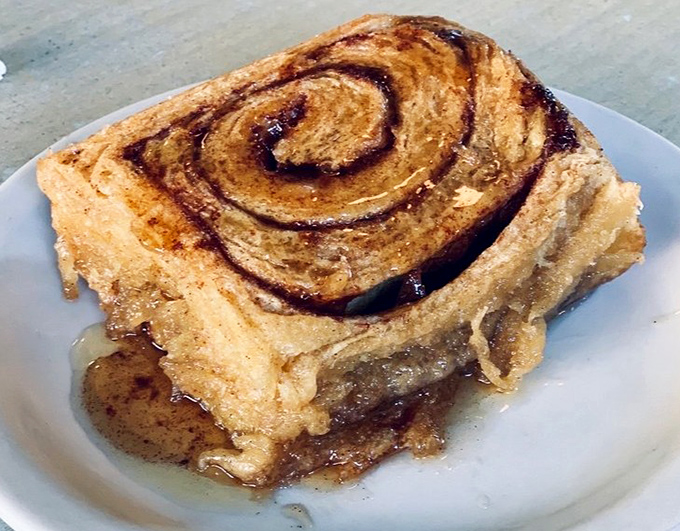 This cinnamon roll isn't just breakfast&mdash;it's dessert masquerading as a morning meal, with swirls of cinnamon that hypnotize you into forgetting about calories entirely.