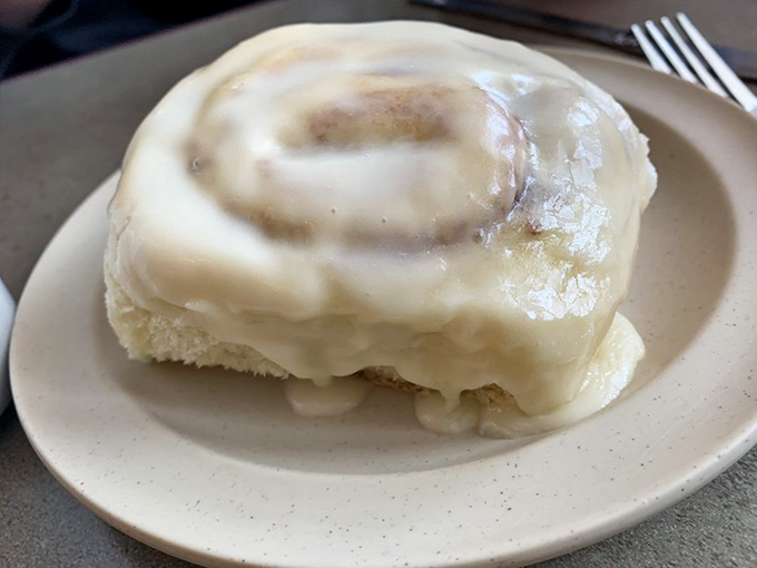 This isn't just any cinnamon roll; it's a pillowy spiral of breakfast bliss that makes Monday mornings bearable again.