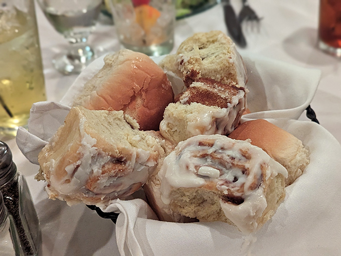 Warm, gooey cinnamon rolls nestled in a basket—the kind of bread service that makes you reconsider your entire relationship with carbs.