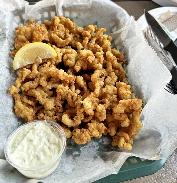 Golden clam strips that crunch like autumn leaves, paired with a dip that makes you forget all your table manners.