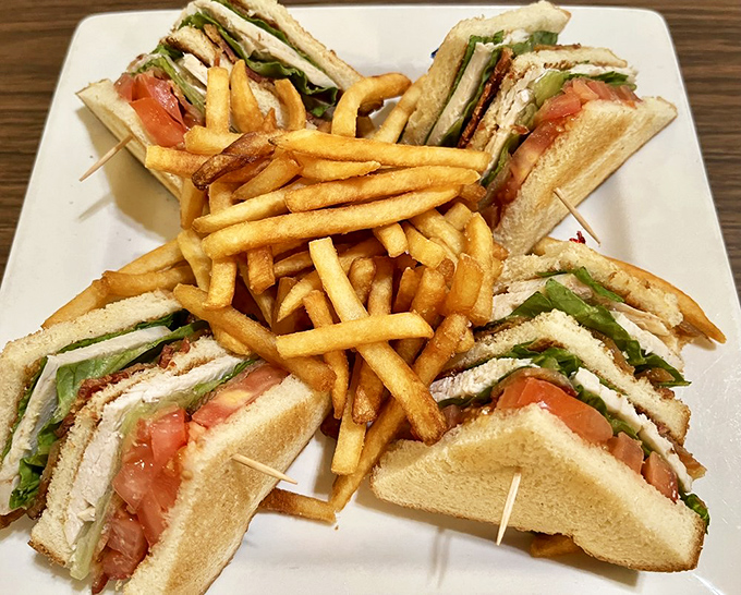The club sandwich, architecture's greatest contribution to lunchtime. Stacked high with fresh ingredients and surrounded by golden fries that demand attention.