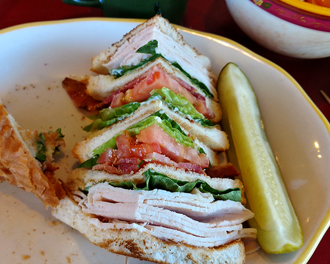 The club sandwich&mdash;architecture you can eat, where each precisely cut triangle reveals layers of craftsmanship that would make Frank Lloyd Wright proud.
