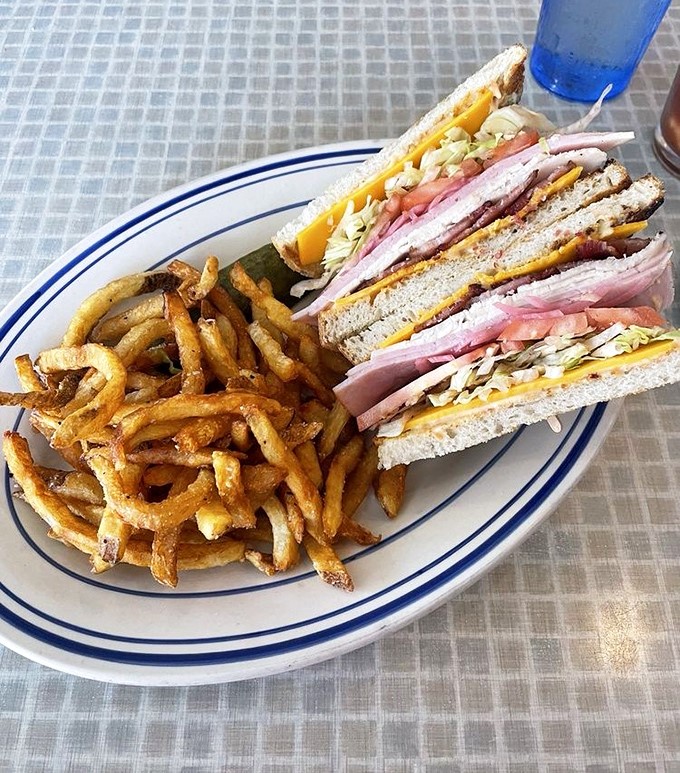 The club sandwich, that reliable diner classic, gets the Comet treatment with layers of meat, cheese, and veggies alongside perfectly crisp fries.