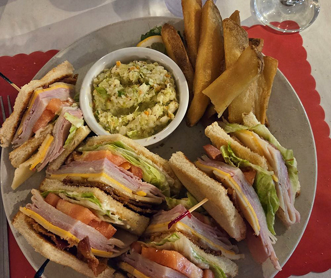 The club sandwich arrives like an architectural marvel&mdash;layers of fresh ingredients flanked by crispy fries and homemade coleslaw that doesn't know it's a side dish.