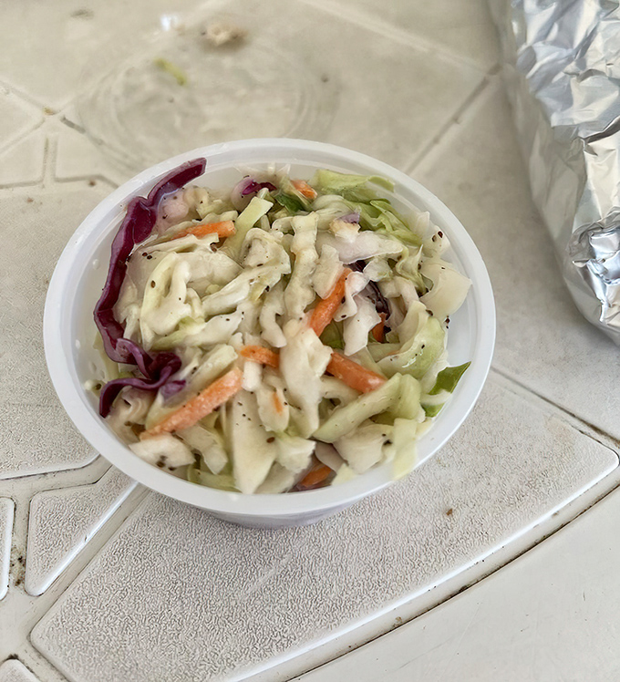 Coleslaw that knows its job: crisp, tangy, and the perfect seafood sidekick.