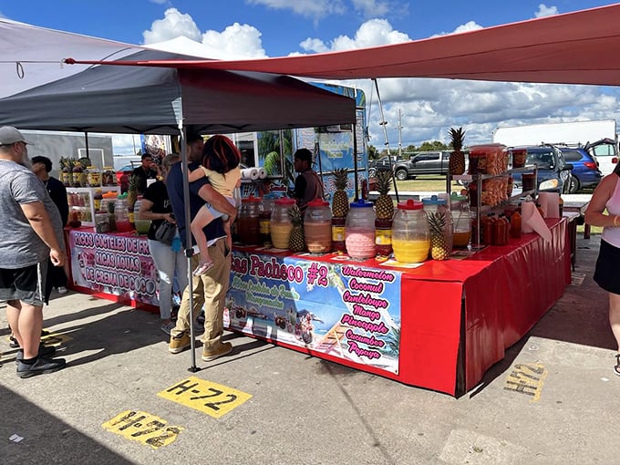 Tropical refreshment central! Fresh-cut pineapples and vibrant fruit drinks offer sweet relief from Florida heat while you contemplate your next market adventure.