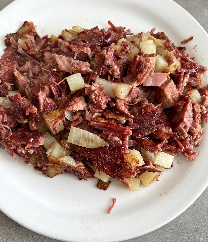 Corned beef hash that doesn't mess around&mdash;chunky, savory, and studded with onions. The kind of breakfast that fuels lumberjacks and software engineers alike.