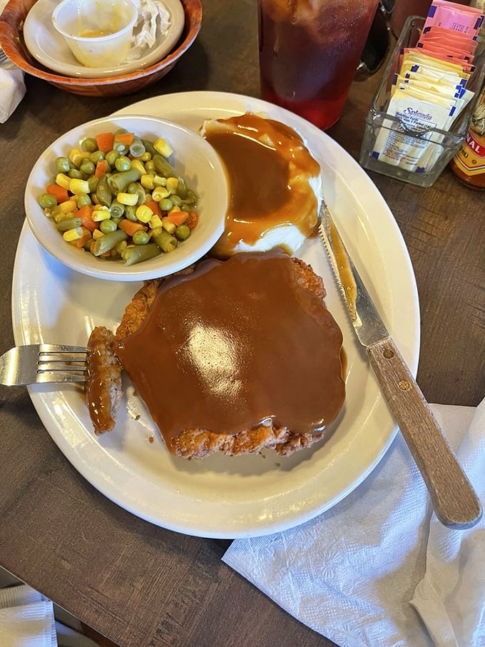 Country fried steak smothered in gravy with mashed potatoes&mdash;a plate that says "nap time is imminent" but worth every drowsy moment.