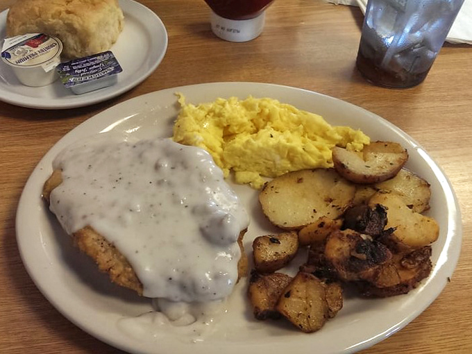 Country fried steak swimming in gravy with eggs and potatoes—the breakfast equivalent of winning the lottery before noon.