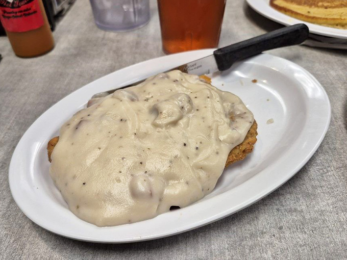 Country fried steak blanketed in peppery gravy covers the plate like a delicious security blanket for your soul.