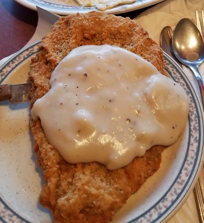Country fried steak drowning in creamy gravy represents everything right about Southern-inspired comfort food.