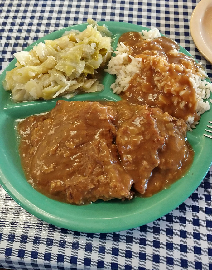 Country fried steak swimming in gravy alongside cabbage and rice. When your plate needs a life preserver, you know you're eating right.