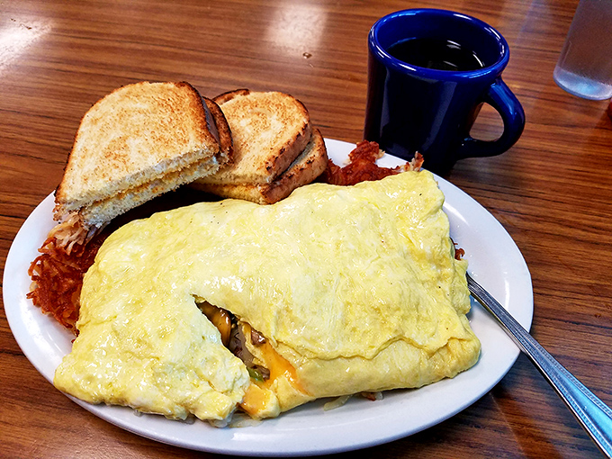 This omelet isn't just big—it's the apartment you wish you could afford in Seattle, with toast acting as the practical roommate.